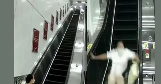 Woman who was going down the escalator gets thrown off after a falling ...